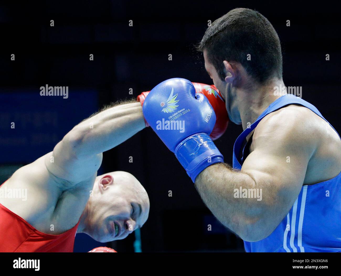 Kazakhstan's Ivan Dychko left, competes against Iran's Jasem Delavari ...