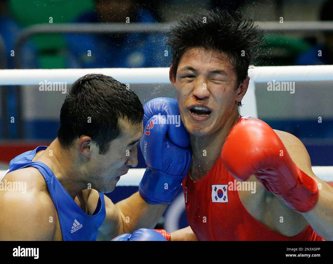 South Korea's Kim Hyeongkyu, right, takes a punch from Kazakhstan's ...