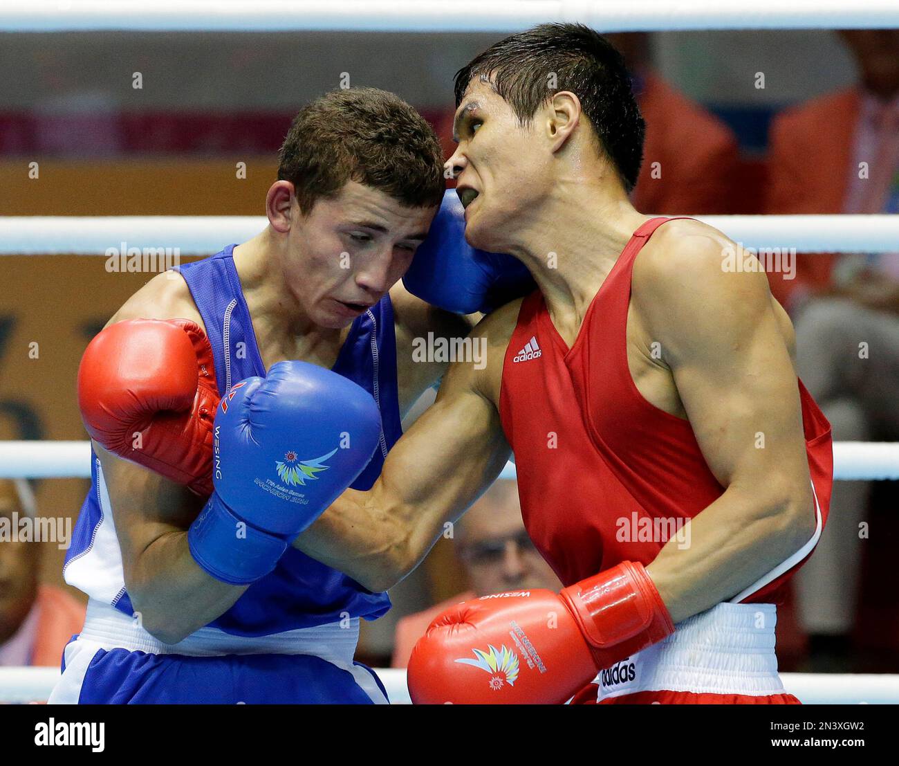 Kazakhstan's Daniyar Yeleussinov, right, competes against Uzbekistan's ...