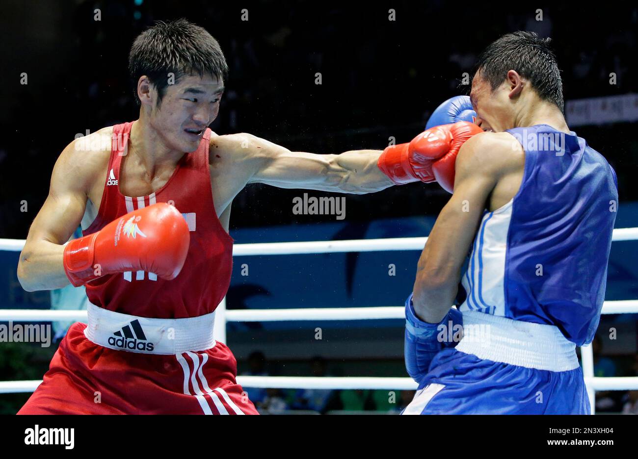 Mongolia's Otgondalai Dorjnyambuu, left, competes against Charly Suarez ...