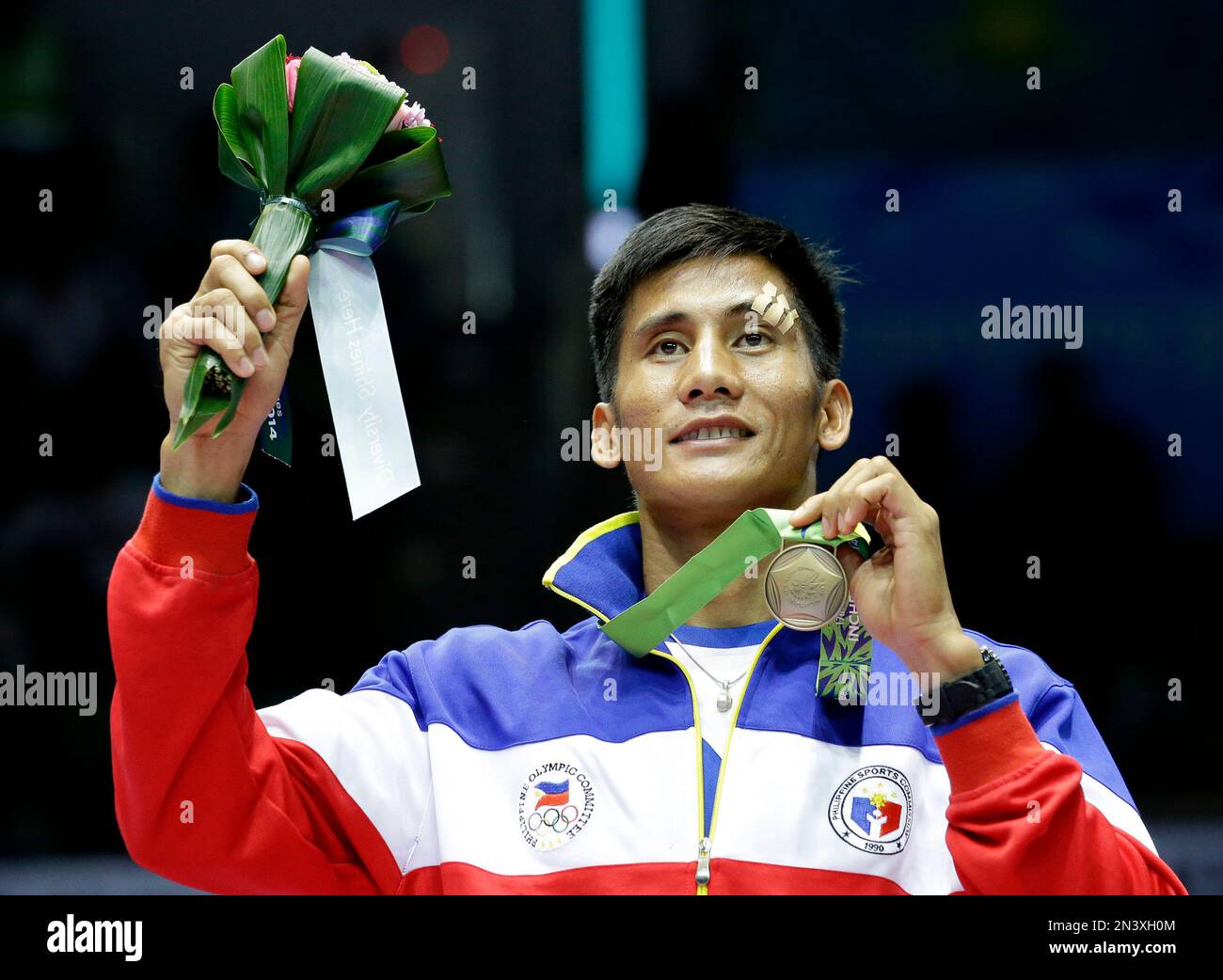Wilfredo Lopez of the Philippines holds up his bronze medal for the men ...