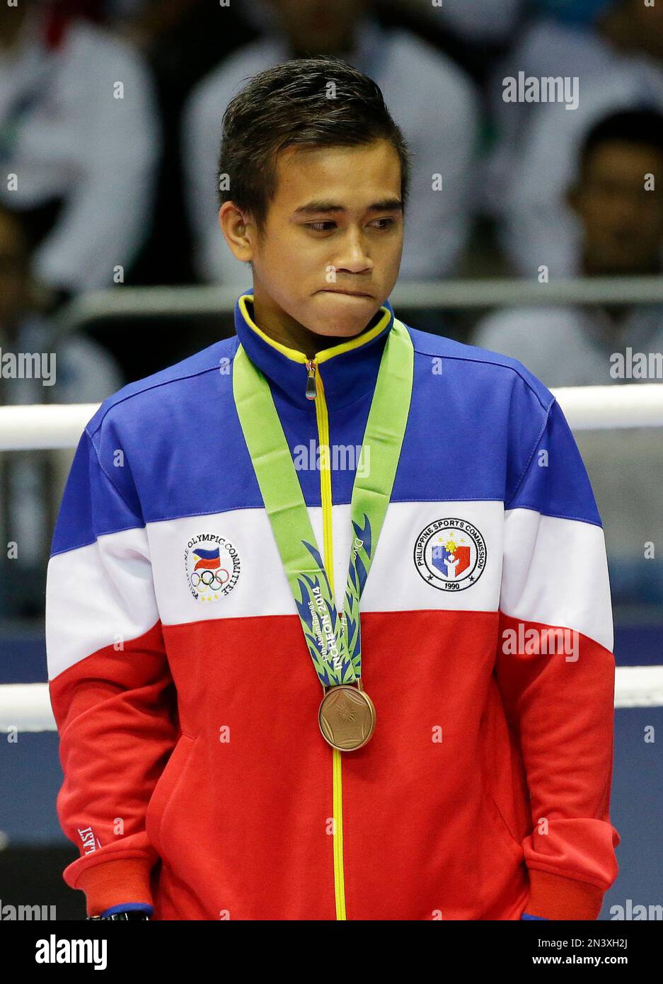 Mark Barriga of the Philippines stands in the ring with his bronze ...