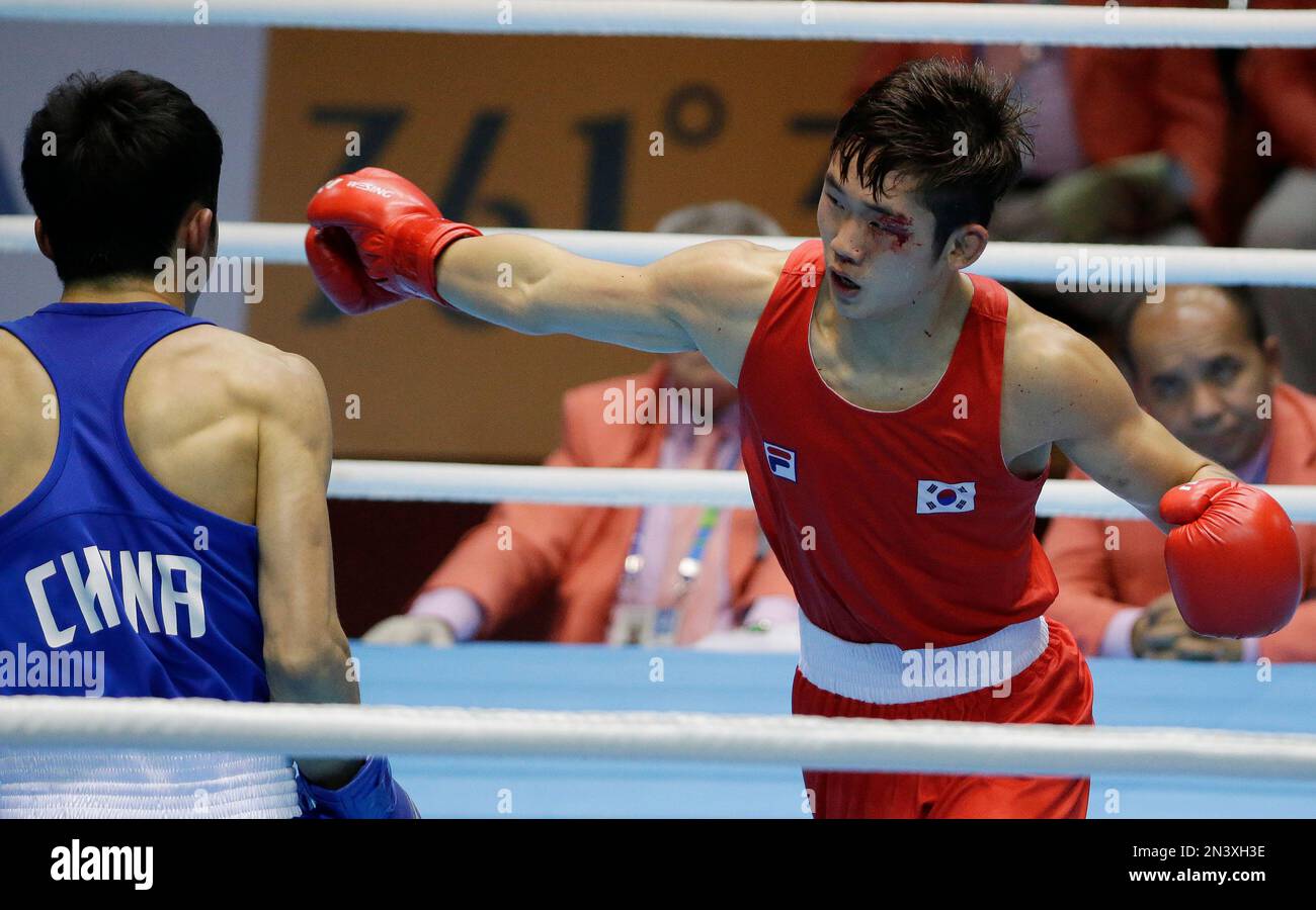 South Korea's Ham Sangmyeong, right, competes against China's Zhang ...