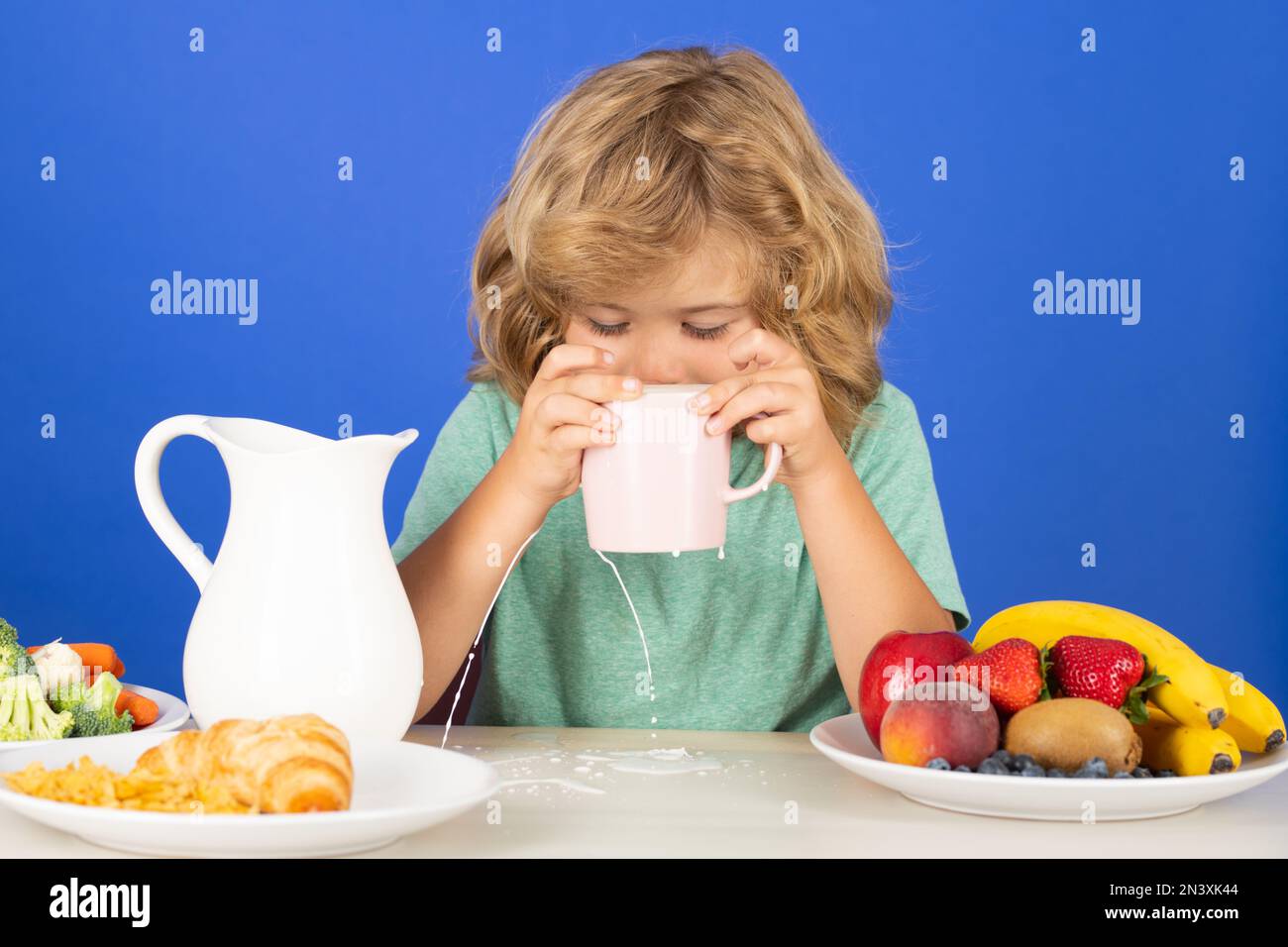 Kid boy pouring whole cows milk. Portrait of child eat fresh healthy ...