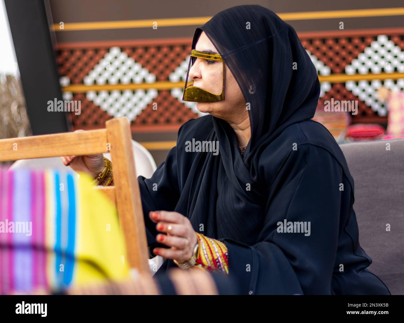 Dubai, UAE - 12.10.2022 - An Arab woman working on traditional craft ...