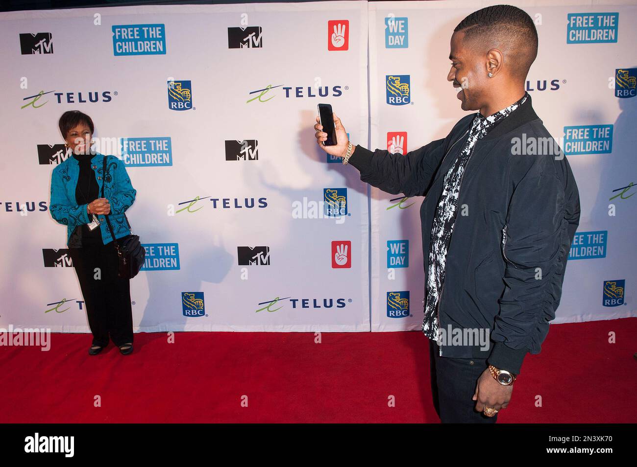 Big Sean, right, takes a picture of his mother Myra Anderson seen ...