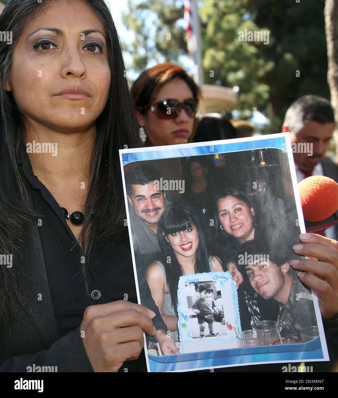 Attorney Claudia Osuna holds a photo of the Crespo family - from top ...