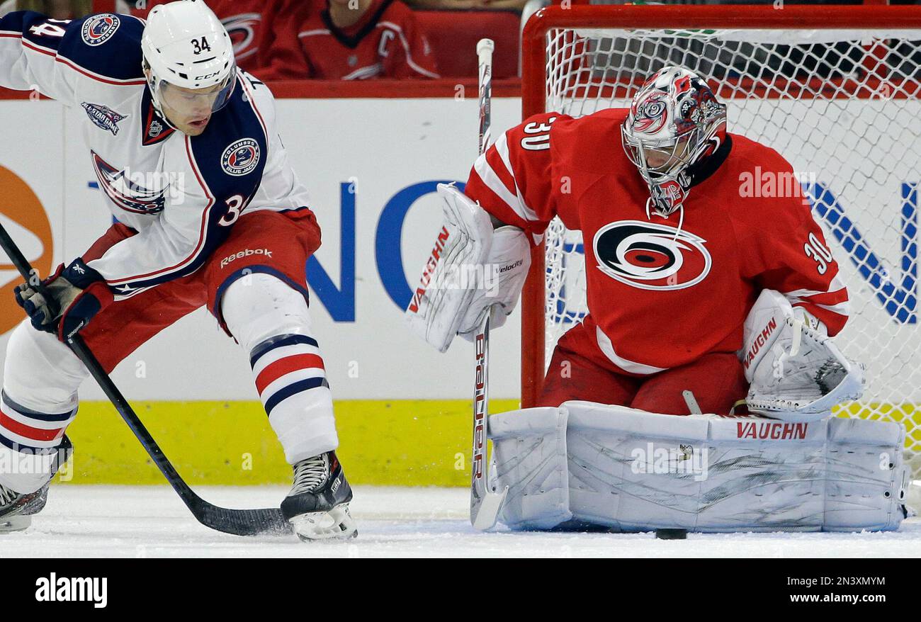 In this Sunday, Sept. 21, 2014 photo Carolina Hurricanes goalie Cam Ward (30) defends against ...