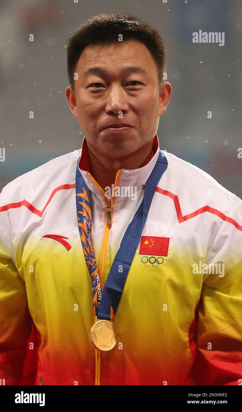 China's Zhao Qinggang who won the gold in the men's javelin throw poses ...