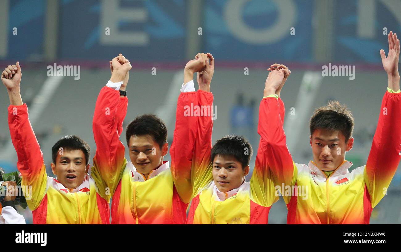 Gold winning Chinese team members pose during the medal ceremony of the ...