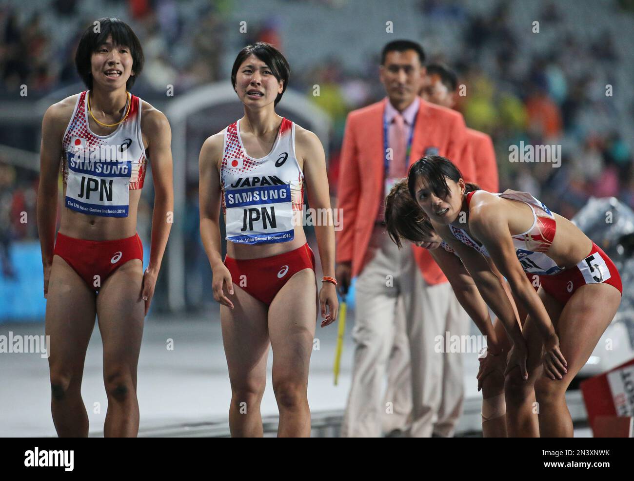 Japan team members react after finishing second in the women's 4 x 400m ...