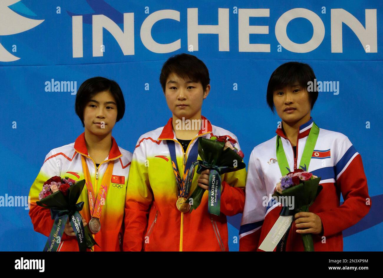 From left, silver medallist China’s Huang Xiaohui, gold medallist China ...