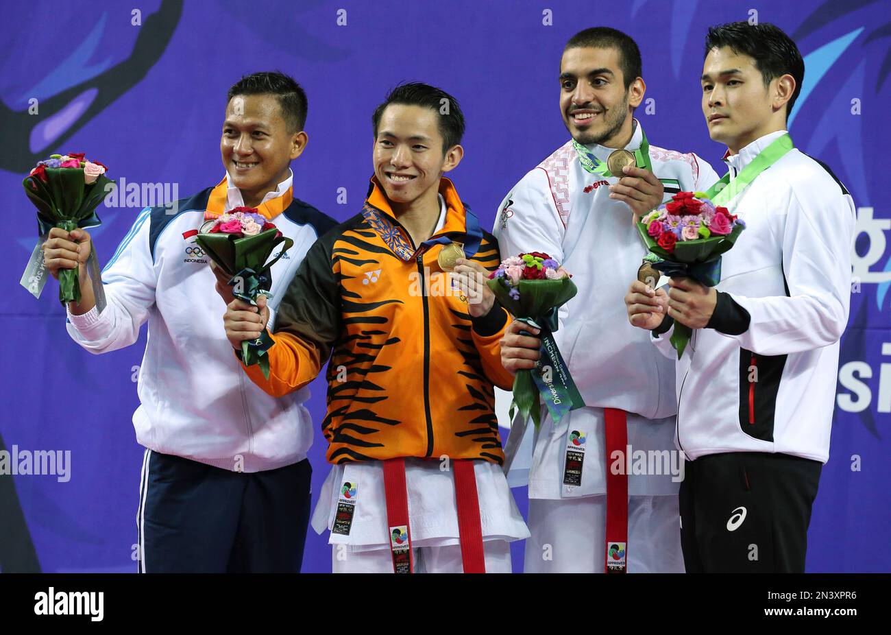 From left, silver medalist Fidelys Lolobua of Indonesia, gold medalist ...
