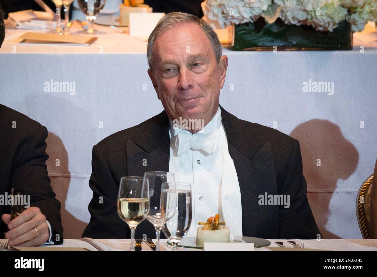 Former New York Mayor Michael Bloomberg reacts to a joke at his expense ...