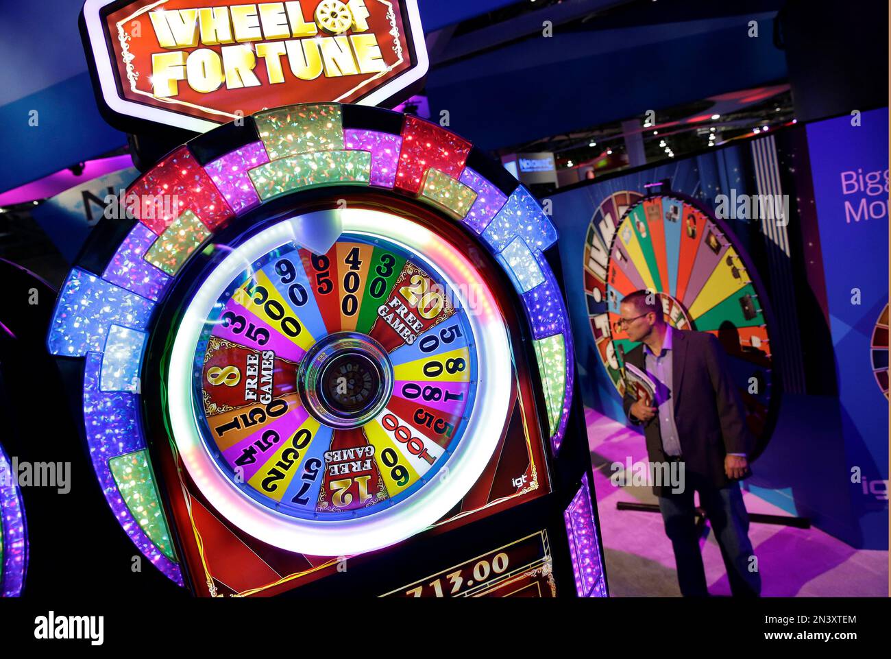 A Wheel of Fortune slot machine is seen at the IGT booth during the ...