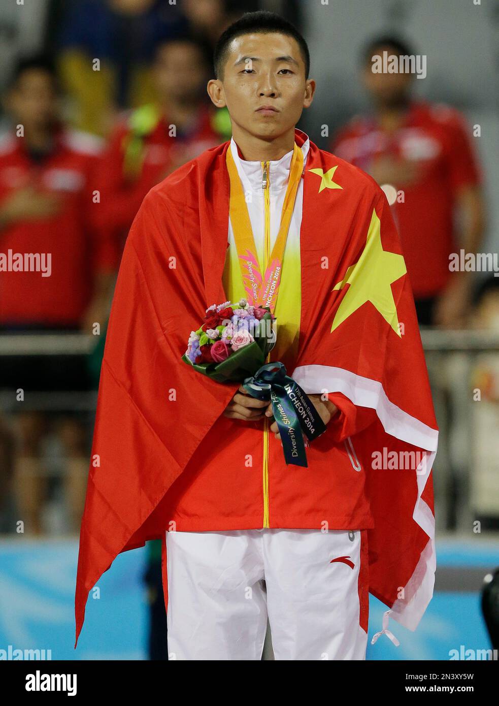 China's Teng Haining stands on the podium after receiving his medal in ...