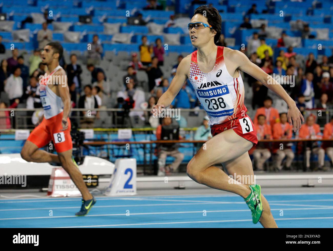 Japan's Takayuki Kishimoto, right, crosses the finish line in second ...
