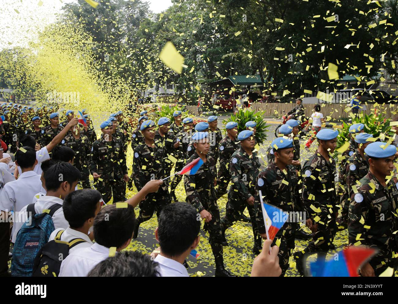 Confetti rain on marching Filipino UN Peacekeepers as they are given a ...