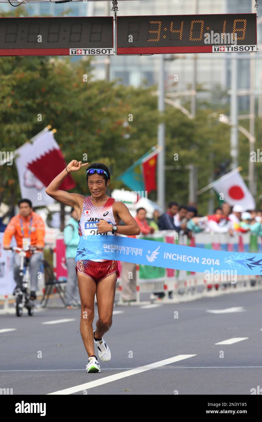Japan’s Takayuki Tanii celebrates as he crosses the finish line to win ...