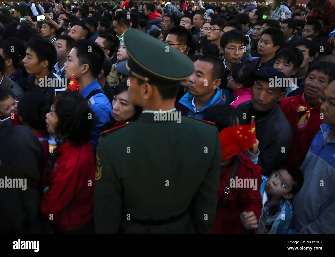 A Chinese paramilitary policeman stands watch the crowds near Tiananmen ...