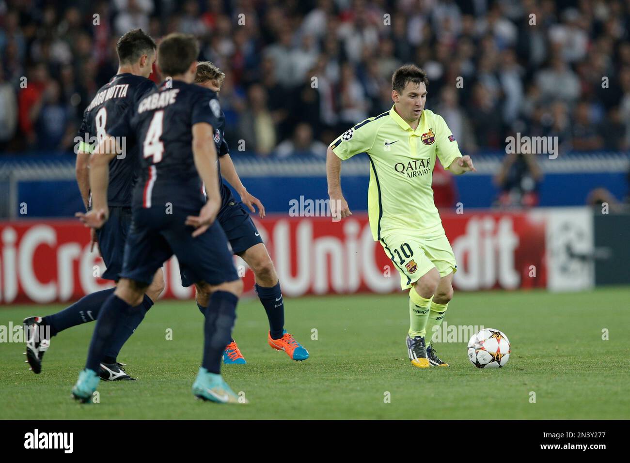 Barcelona's Lionel Messi, right, is faced by a wall of PSG defenders ...