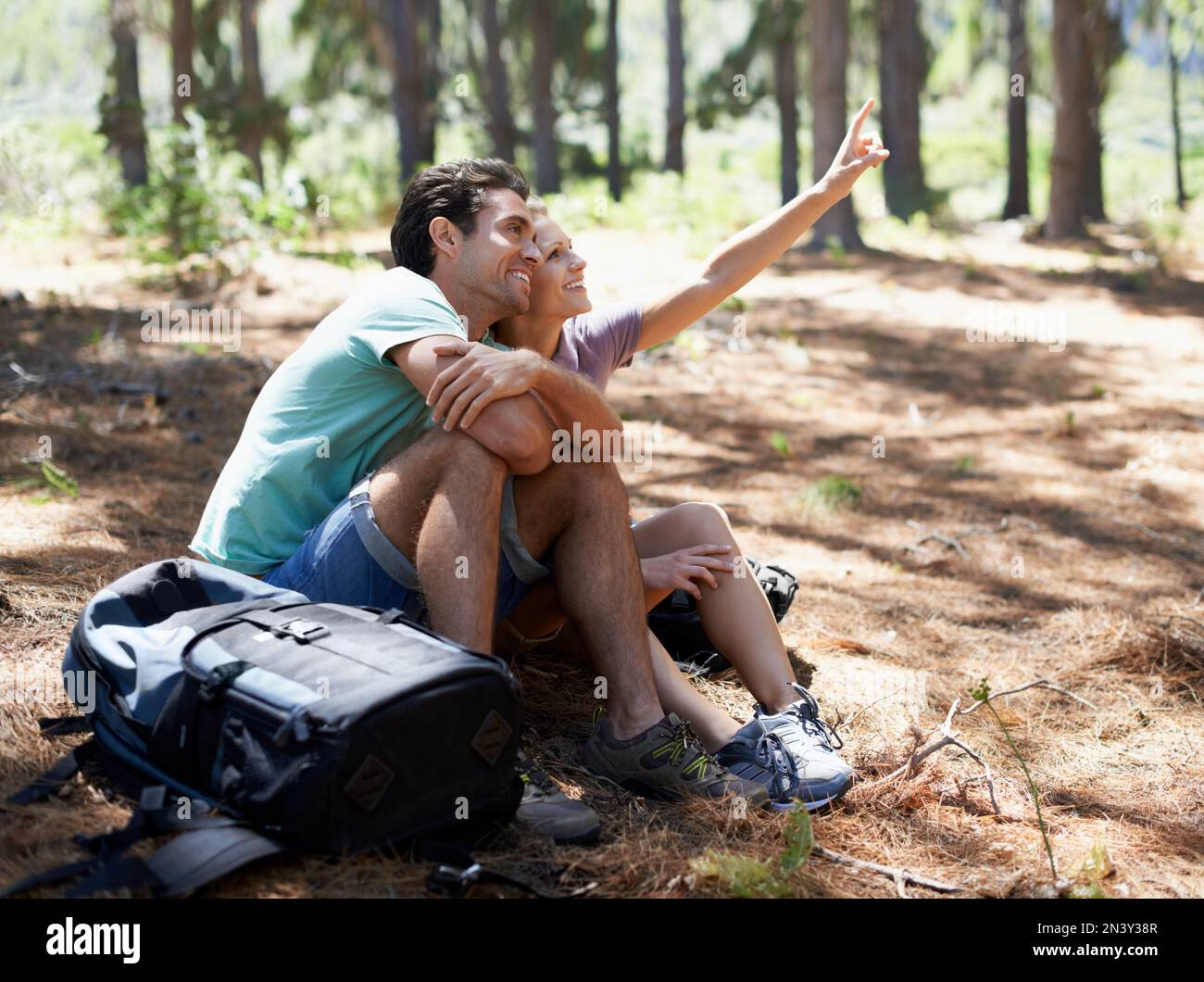 Sharing a passion for nature. A happy young couple sitting on the ...