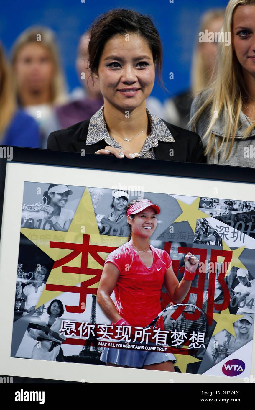 Chinese tennis player Li Na holds a picture of her during her ...