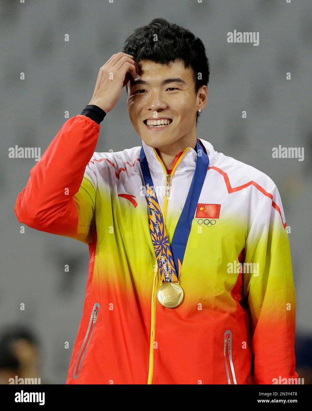China's Xie Wenjun smiles on the podium after receiving his gold medal ...