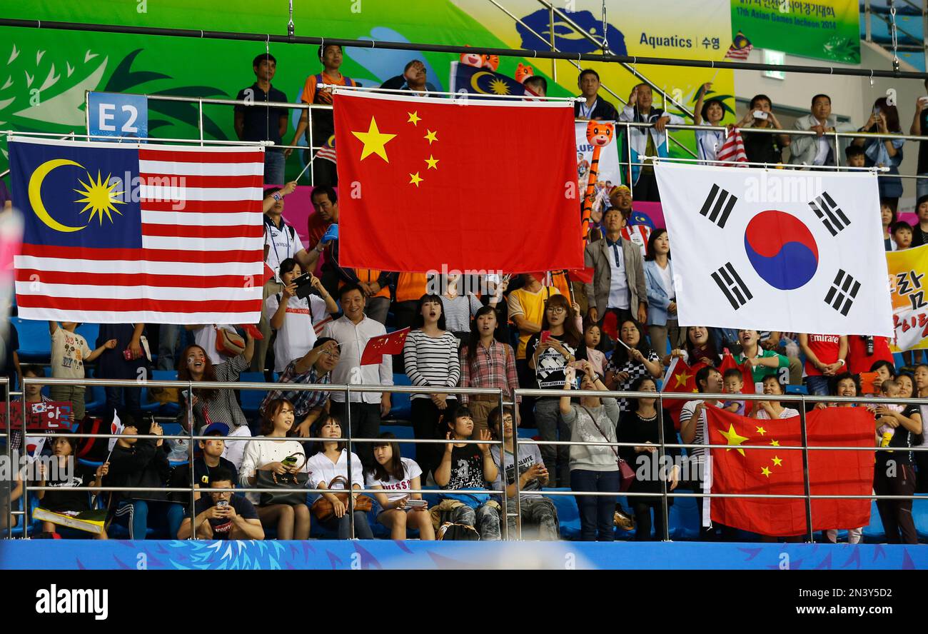 From left, Malaysian, Chinese and South Korean national flags hang by ...