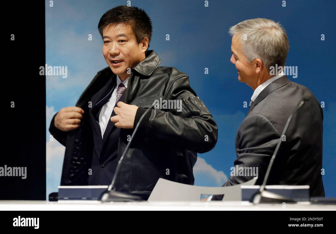 Song Zhiyong, left, president of Air China, puts on a leather flight ...