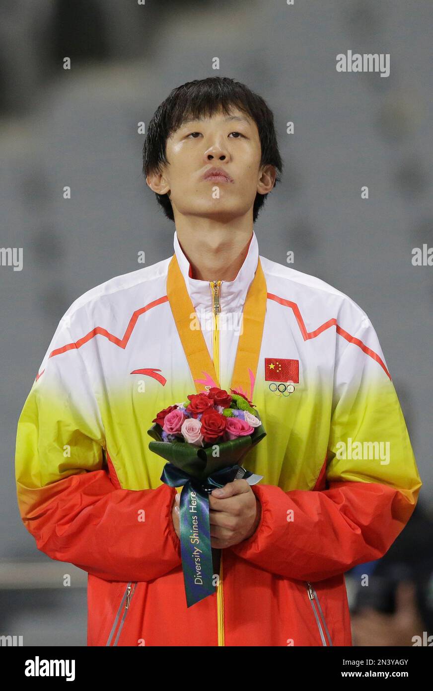 Silver medalist China's Zhang Guowei stands at the podium during the ...