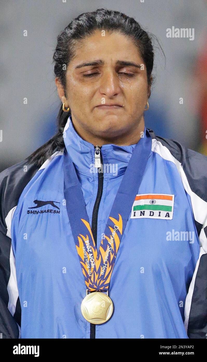 India's Seema Punia cries after receiving the gold medal for women's ...
