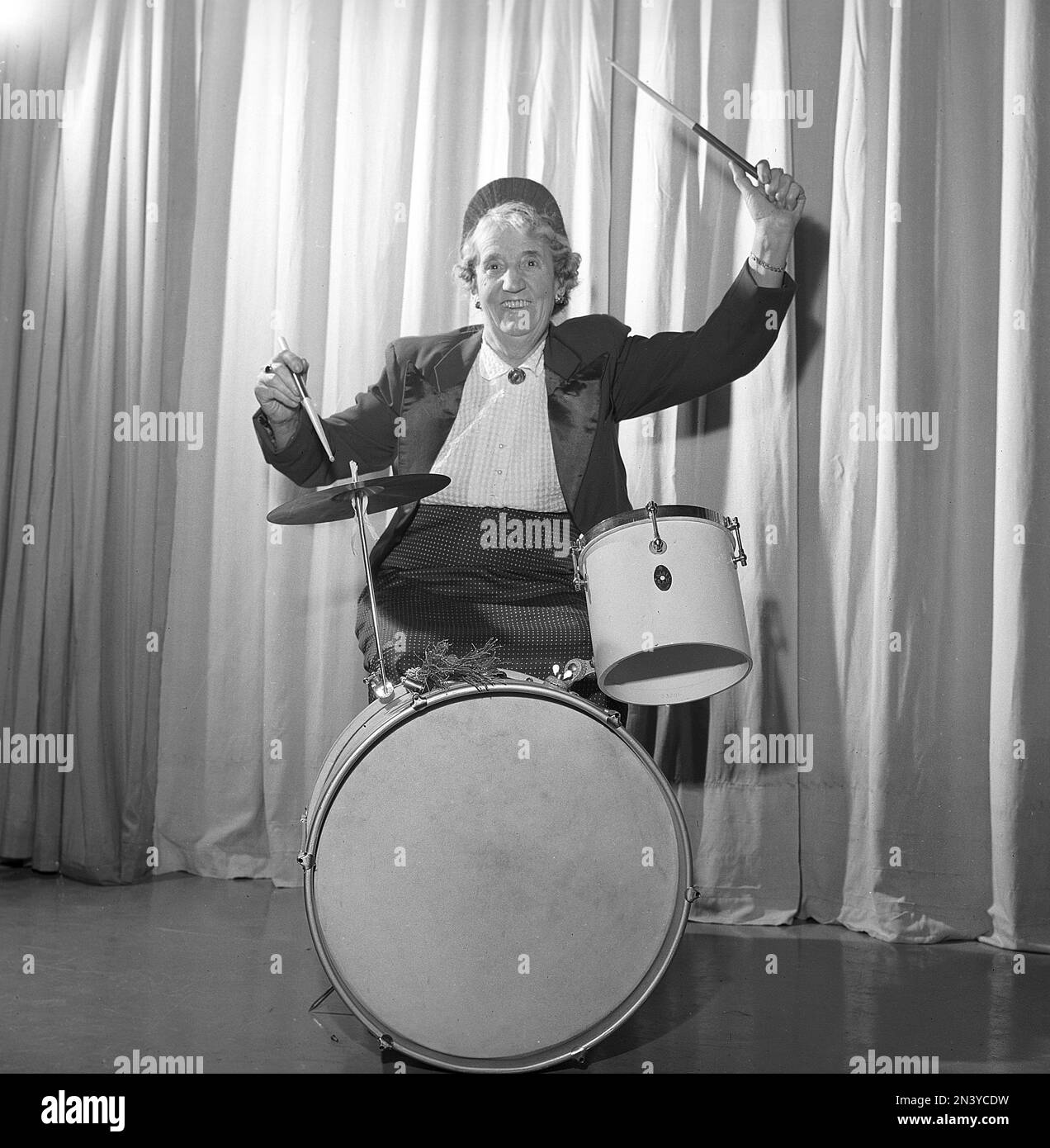 In the 1950s. An elderly lady playing drums. She is actress Julia ...