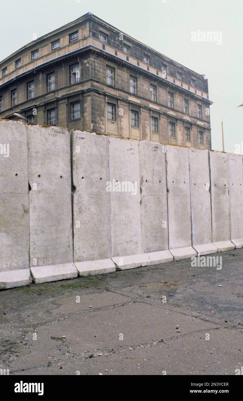 The Berlin Wall. A guarded concrete barrier that encircled West Berlin ...