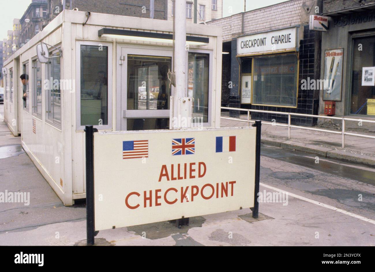 The Berlin Wall. A guarded concrete barrier that encircled West Berlin ...