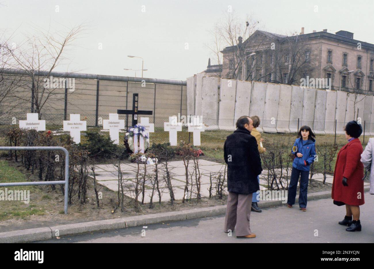 The Berlin Wall. A guarded concrete barrier that encircled West Berlin ...