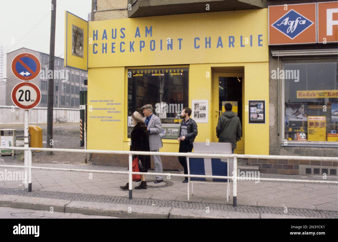 The Berlin Wall. A guarded concrete barrier that encircled West Berlin ...