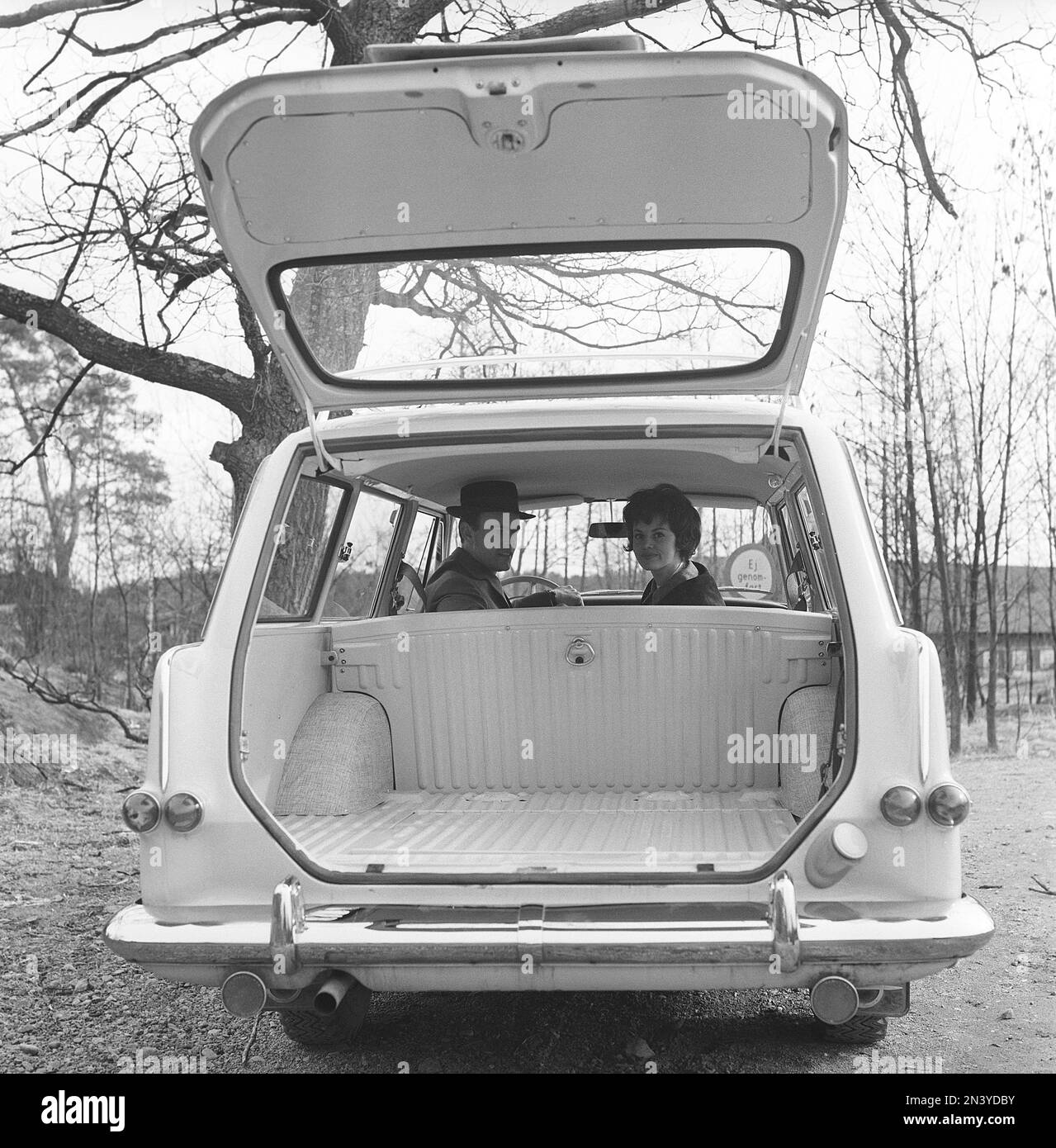 Driving in the 1960s. A couple is seen sitting in their car, an Opel ...