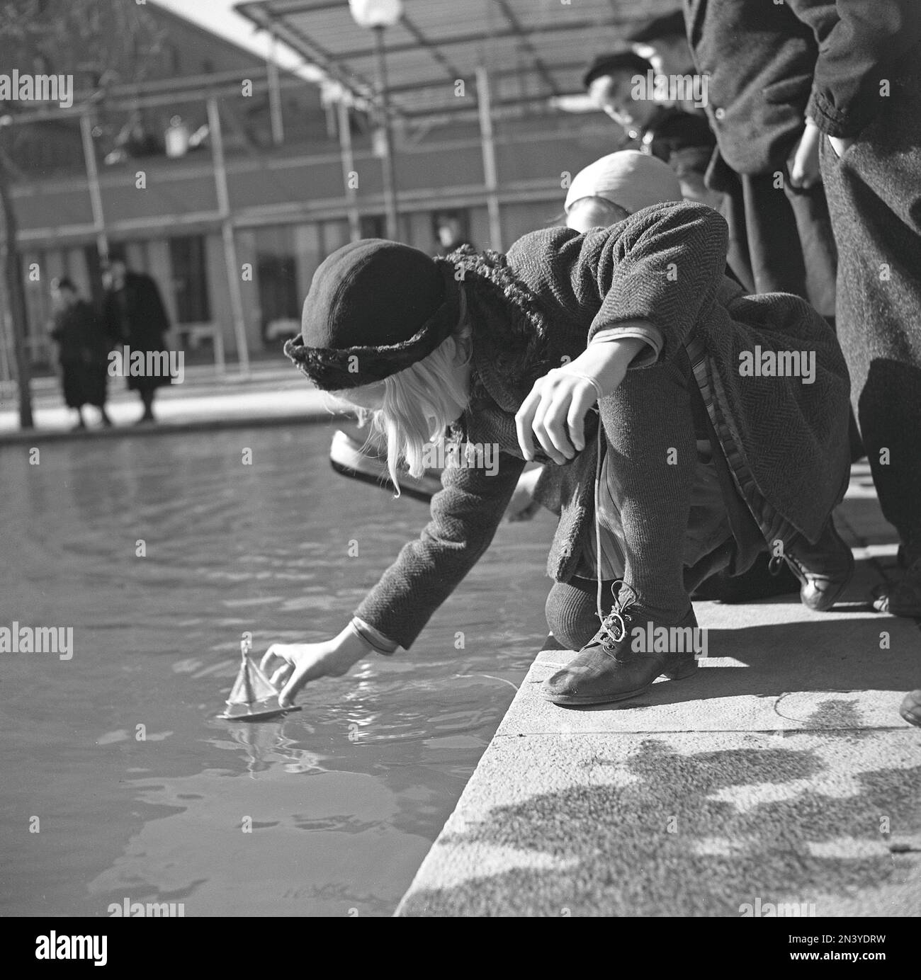 In the 1940s. A girl with a small model sailboat pictured on this spring day in Stockholm at the ...