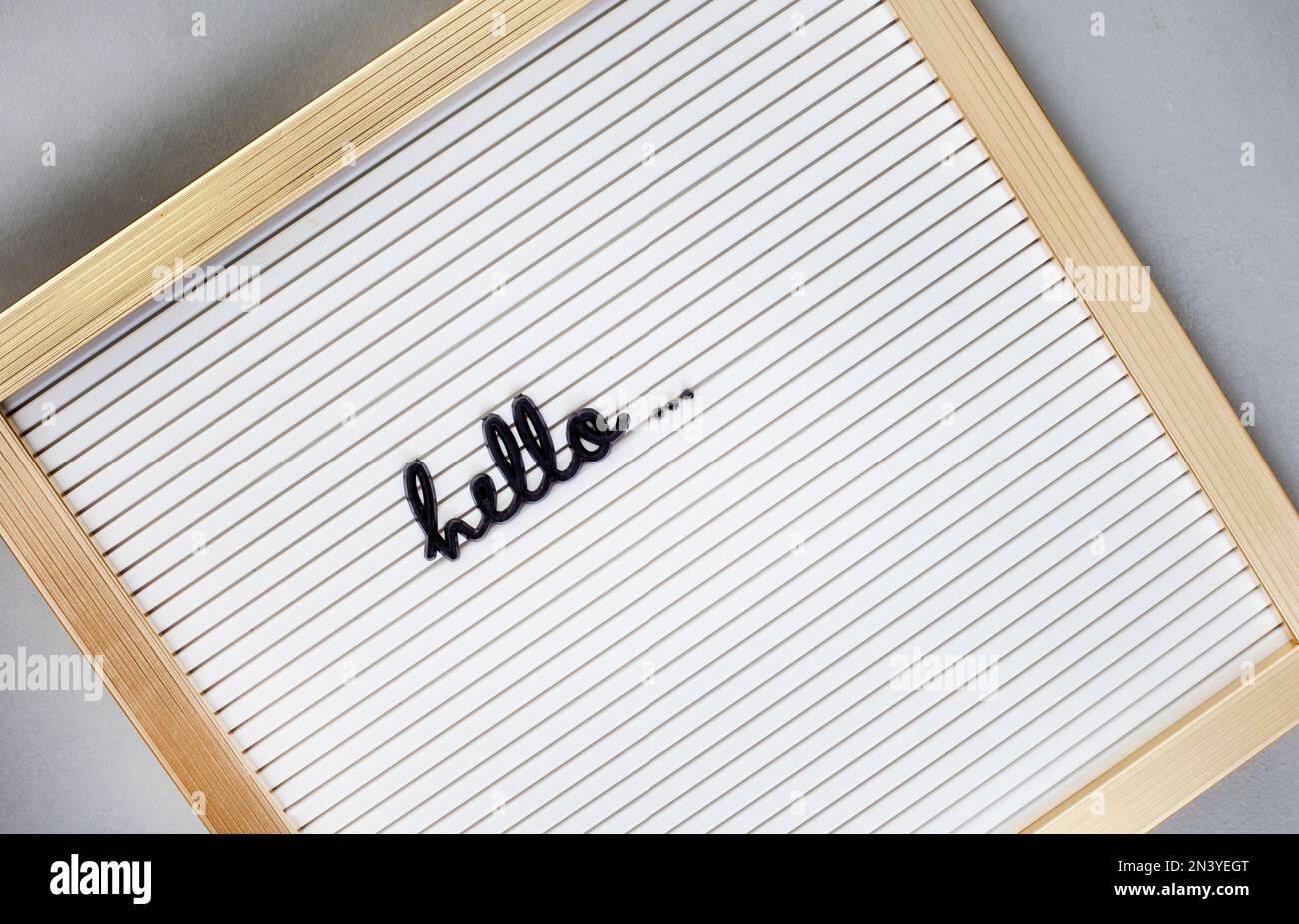 letter board with Hello written in cursive with golden frame and ...
