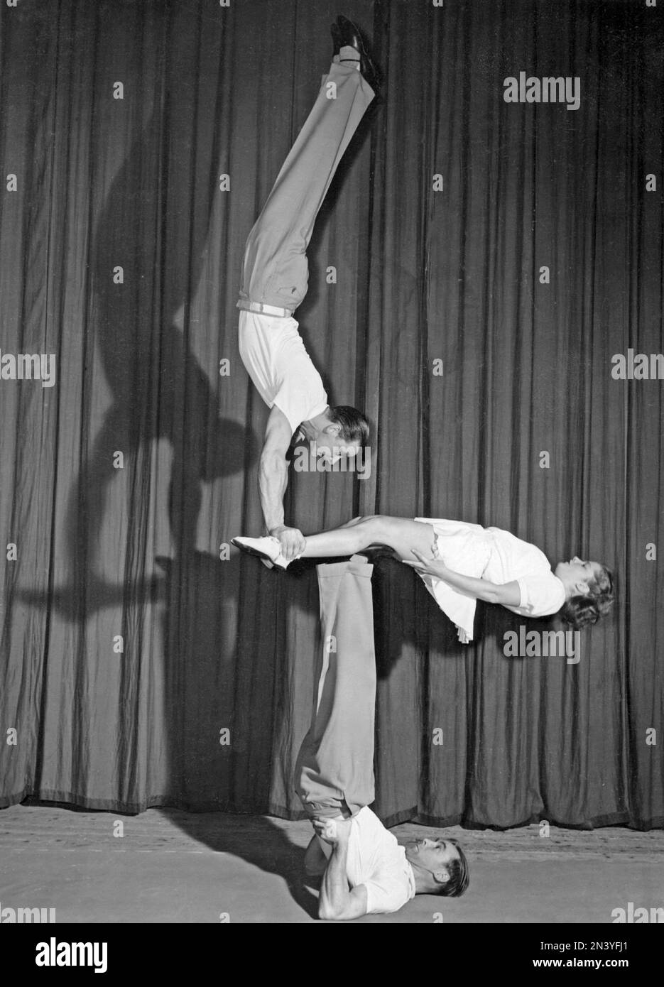 1940s acrobatic show. The three acrobats performs a balance act on ...