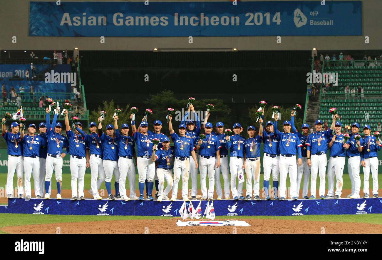 South Korea's baseball team players pose for photos on the podium ...