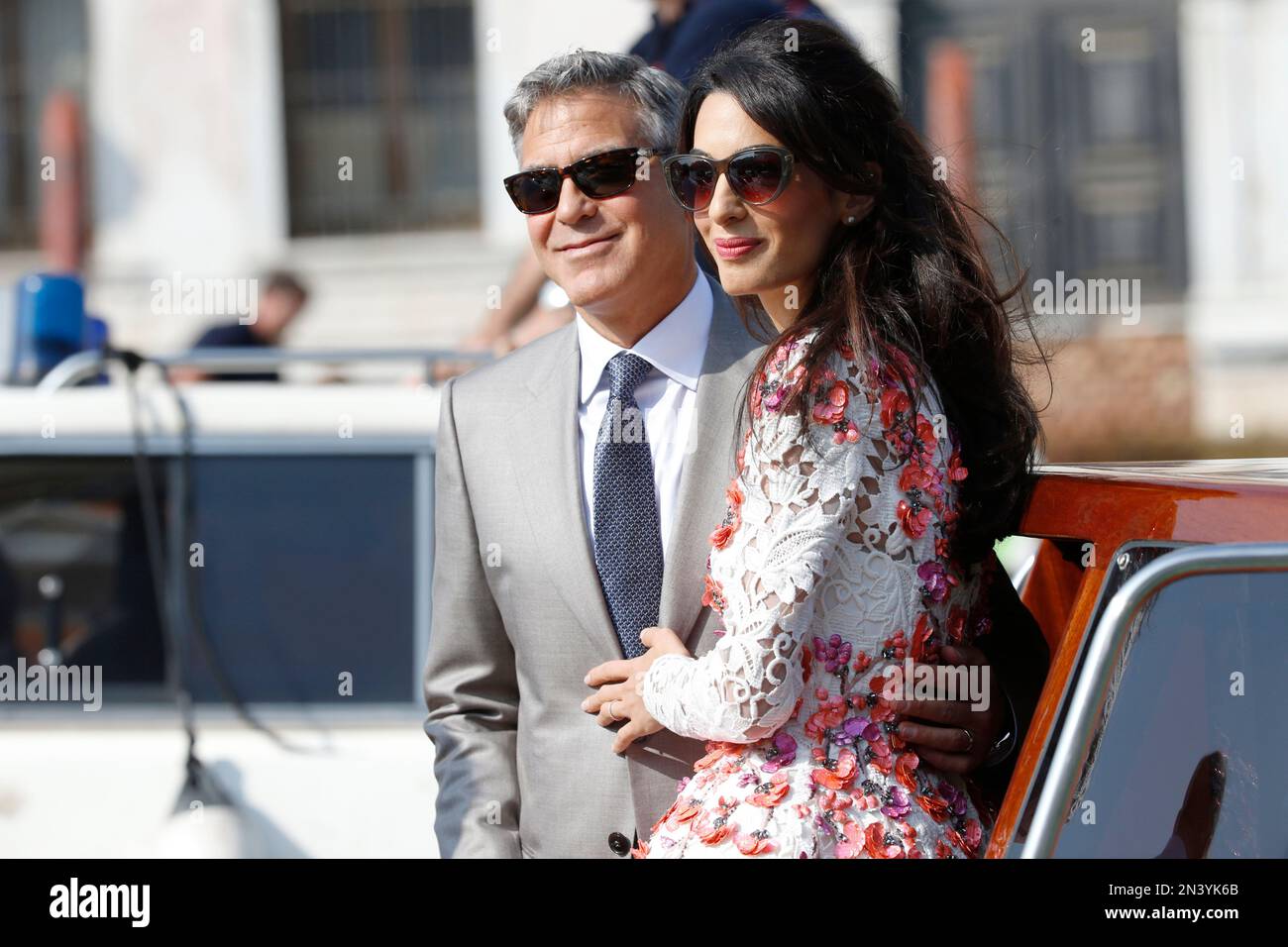 George Clooney is flanked by his wife Amal Alamuddin as they leave the ...