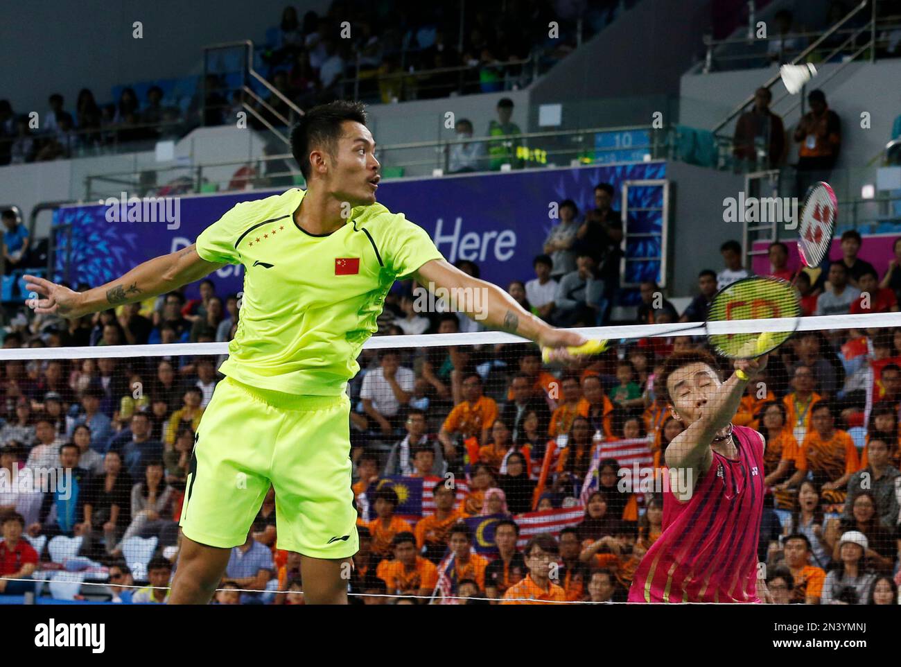 China's Lin Dan, left returns a shot to Malaysia's Lee Chong Wei, right ...