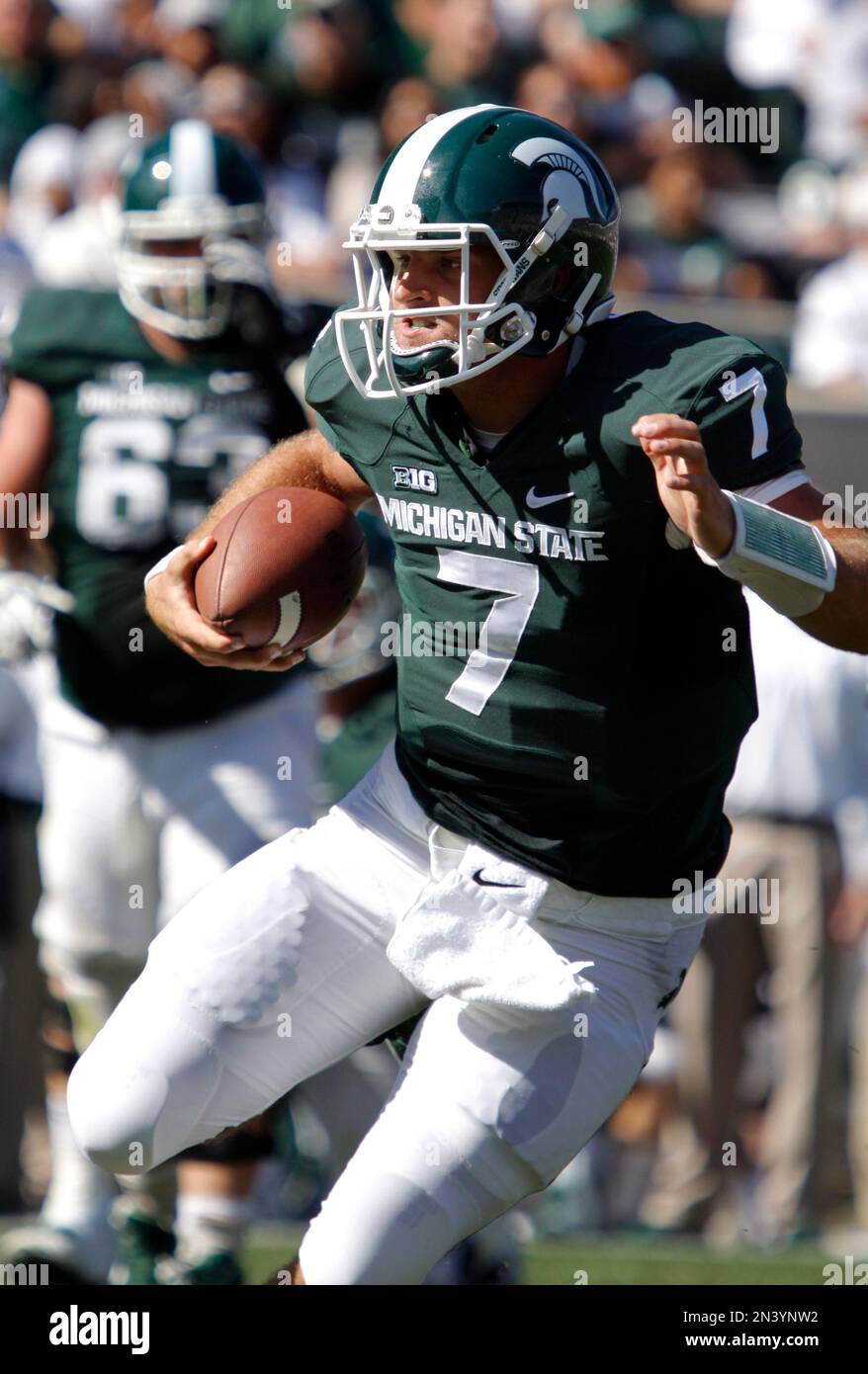 Michigan State quarterback Tyler O'Connor runs for a 12-yard touchdown ...