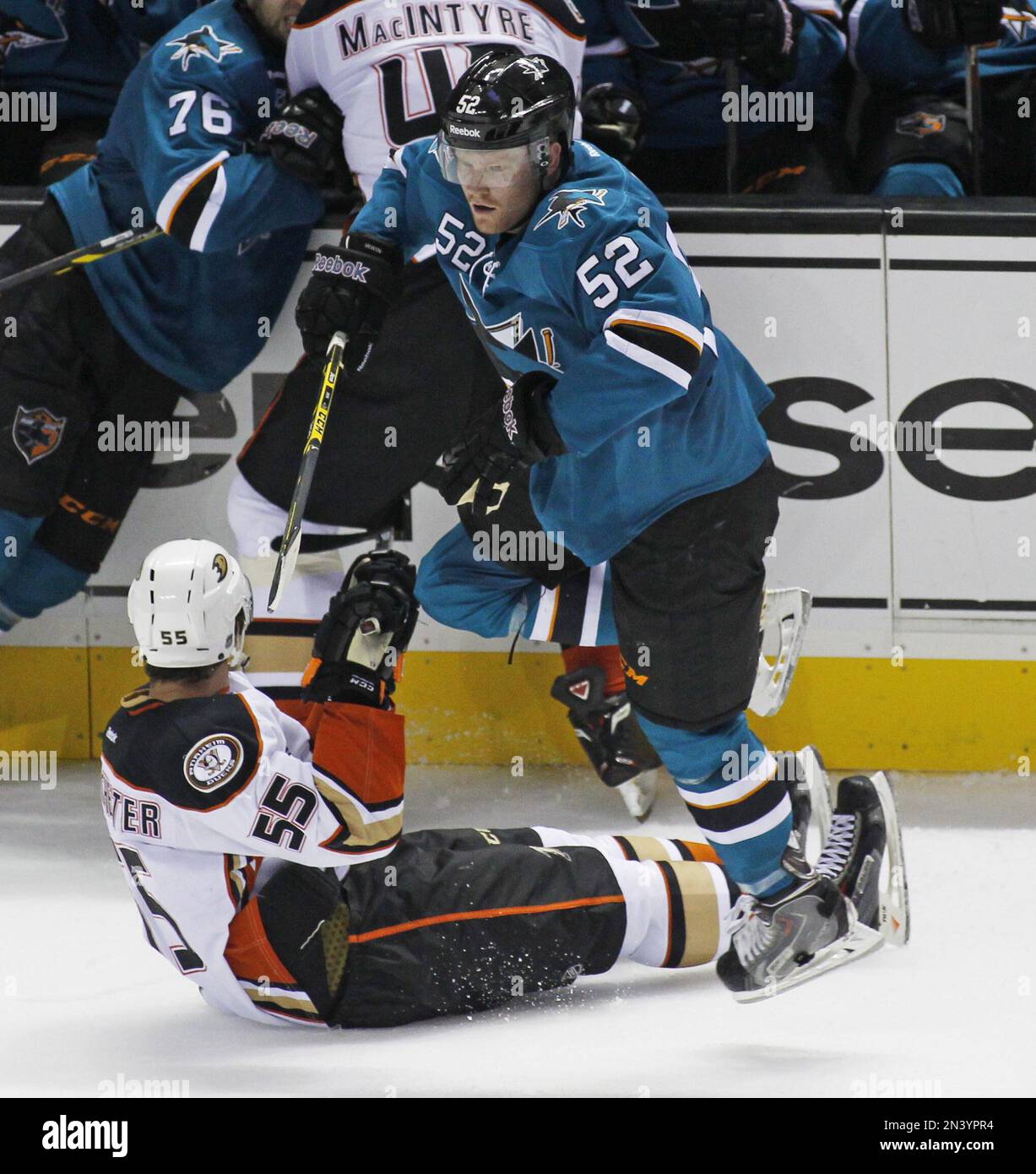 San Jose Sharks' Matt Irwin steps over Anaheim Ducks' Brad Winchester ...
