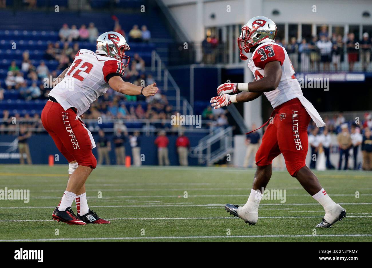 Western Kentucky quarterback Brandon Doughty, left, high-fives teammate ...