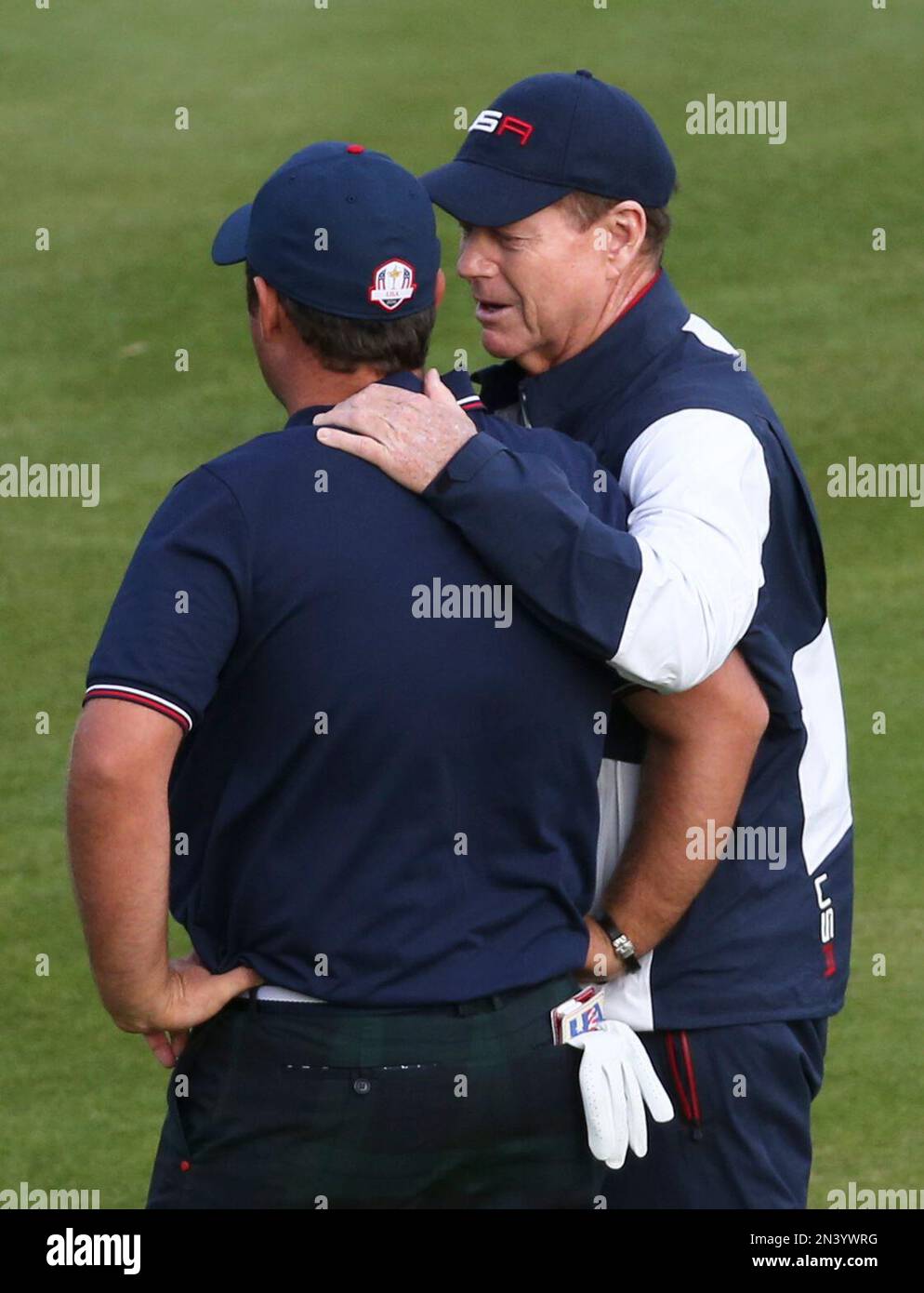 US team captain Tom Watson consoles Patrick Reed after losing the 18th ...