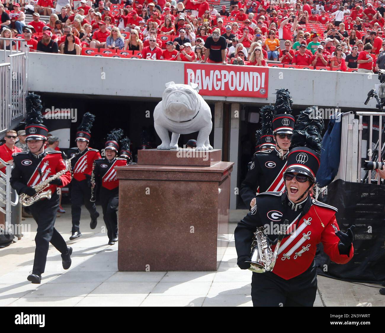 members of the Georgia's Red Coat Marching band take to the field ...