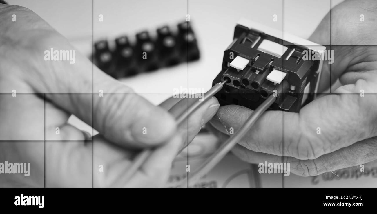 Electrician hands connecting a wire into a power socket, geometric ...